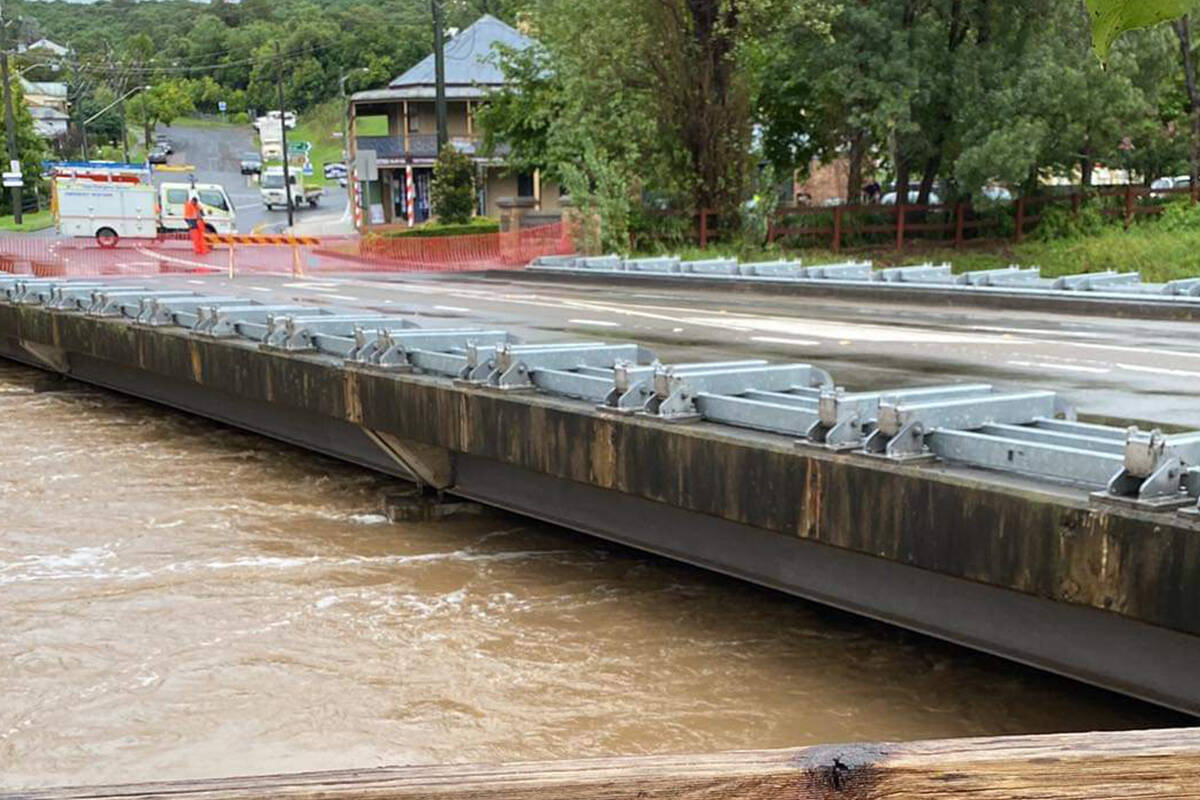 Waters lap at Picton Bridge as heavy rains continue