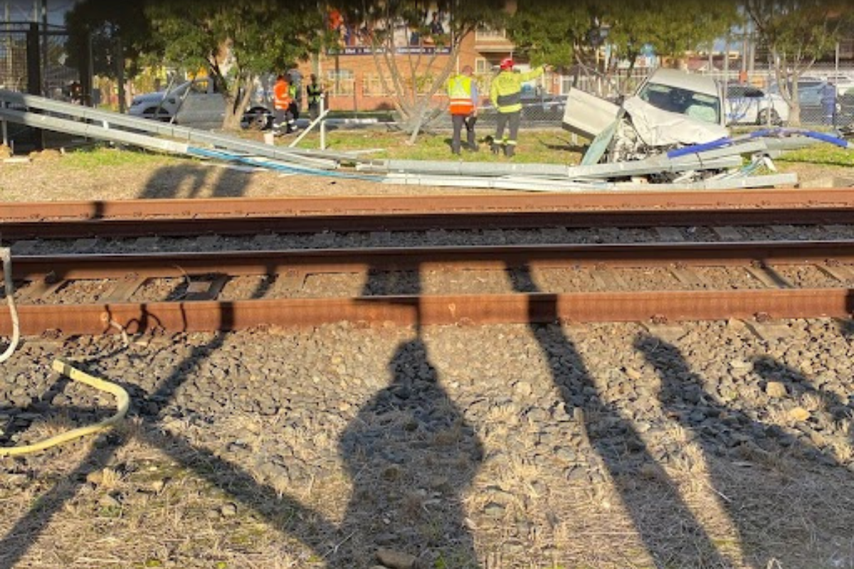 Trains stopped after car crashes onto railway tracks in Sydney's west
